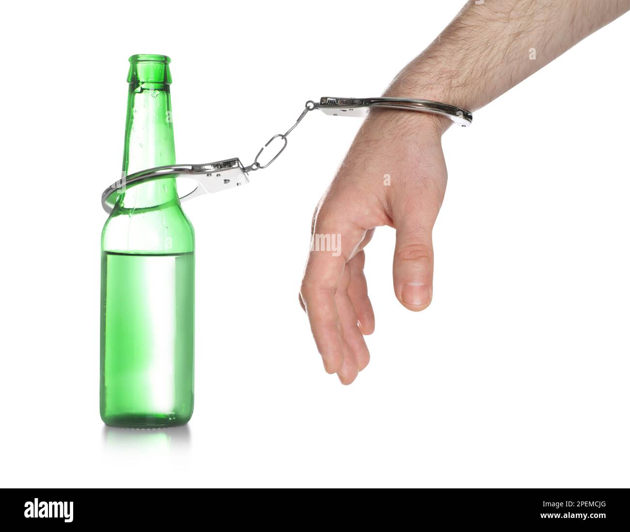 Man in handcuffs with bottle of beer on white background, closeup ...