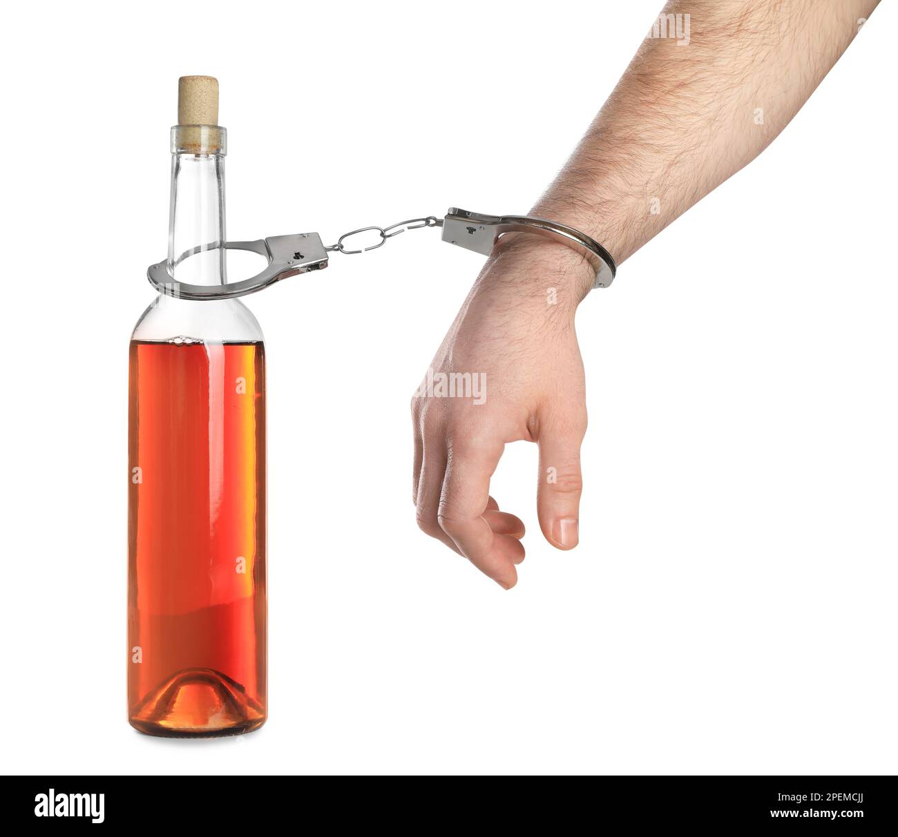 Addicted man in handcuffs with bottle of alcoholic drink on white ...