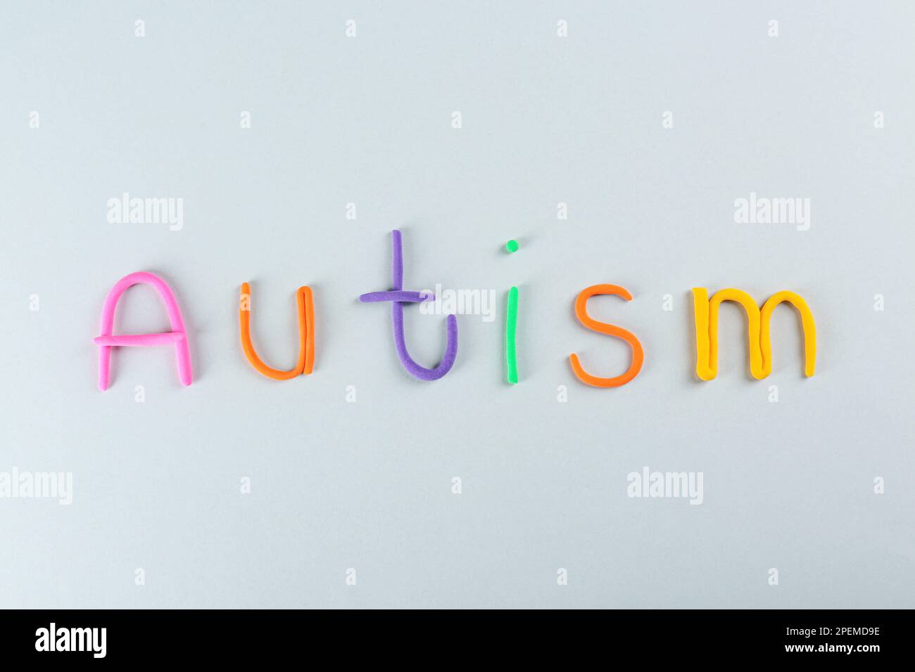 Word Autism made with colorful plasticine on white background, top view ...