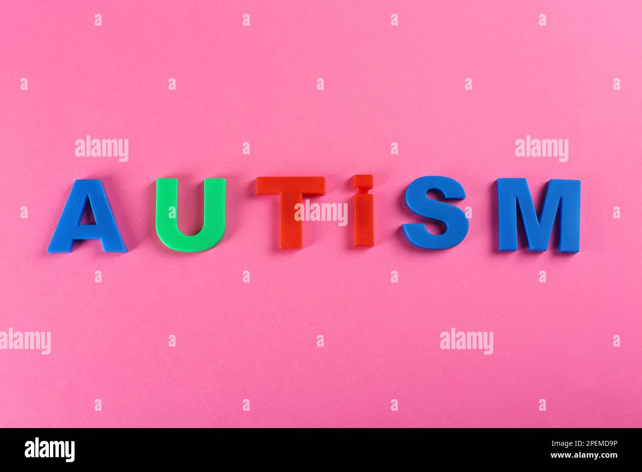Word Autism made with colorful letters on pink background, top view ...