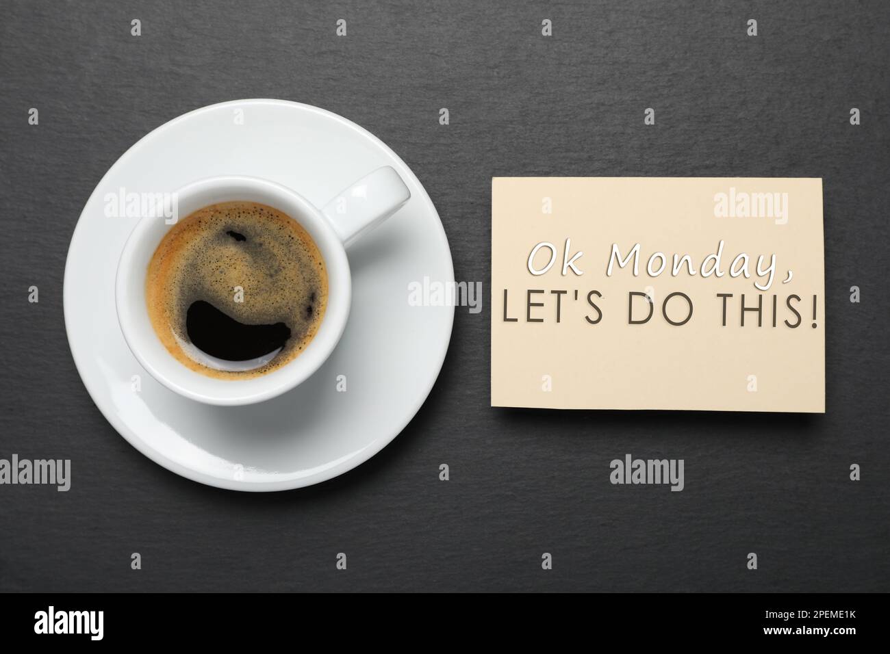 Cup of hot espresso and card with motivational quote OK Monday, Let's ...