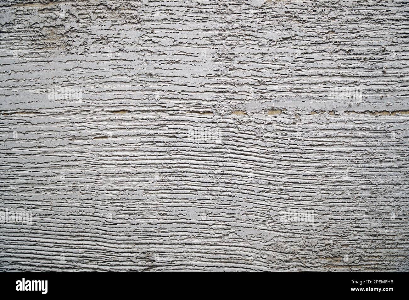 Gray decorative plaster on the wall with pressed horizontal stripes ...