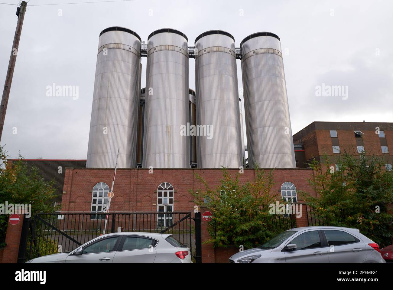 Tall vertical liquid storage tanks at a brewery Stock Photo - Alamy
