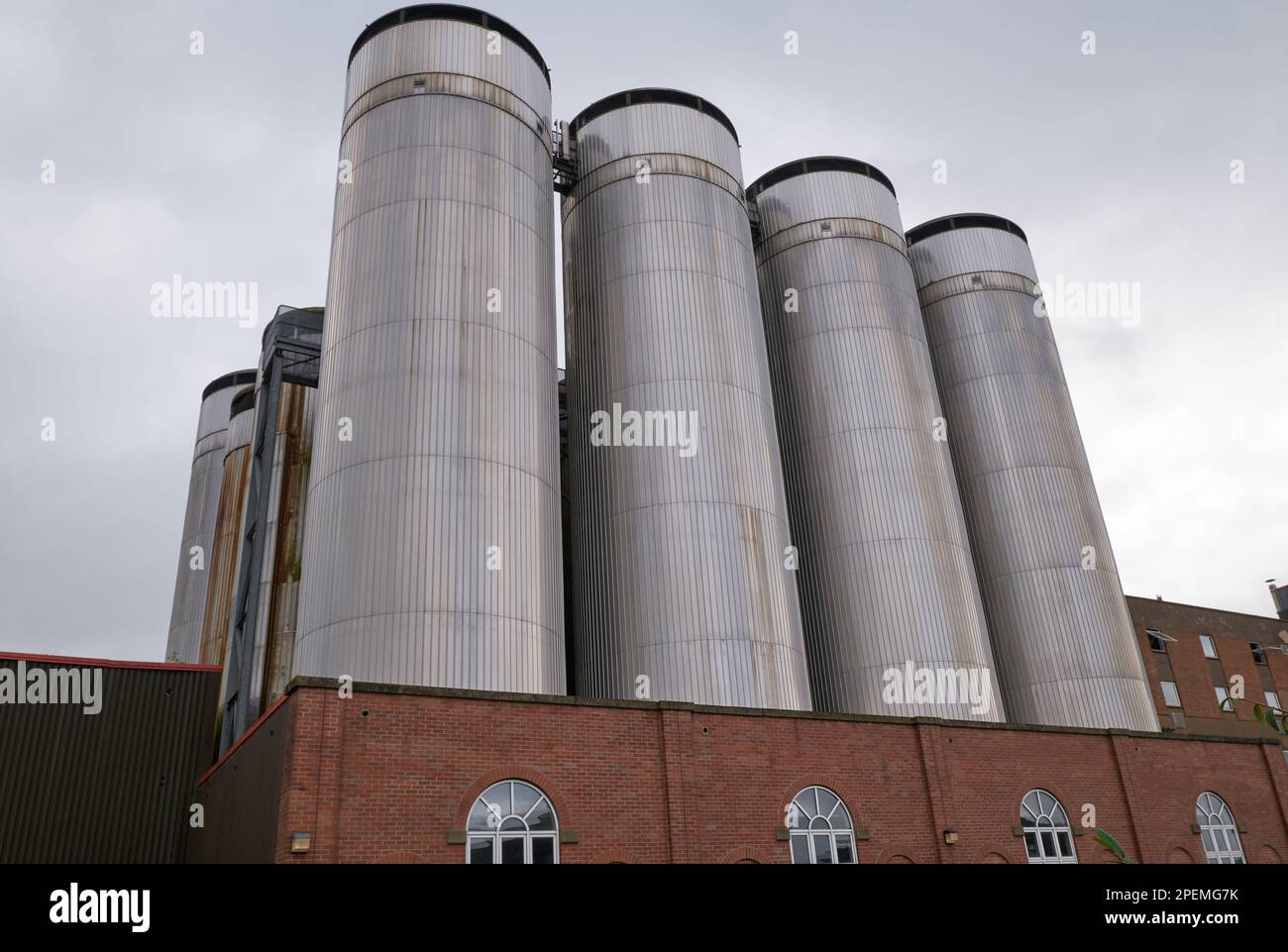 Tall vertical liquid storage tanks at a brewery Stock Photo - Alamy