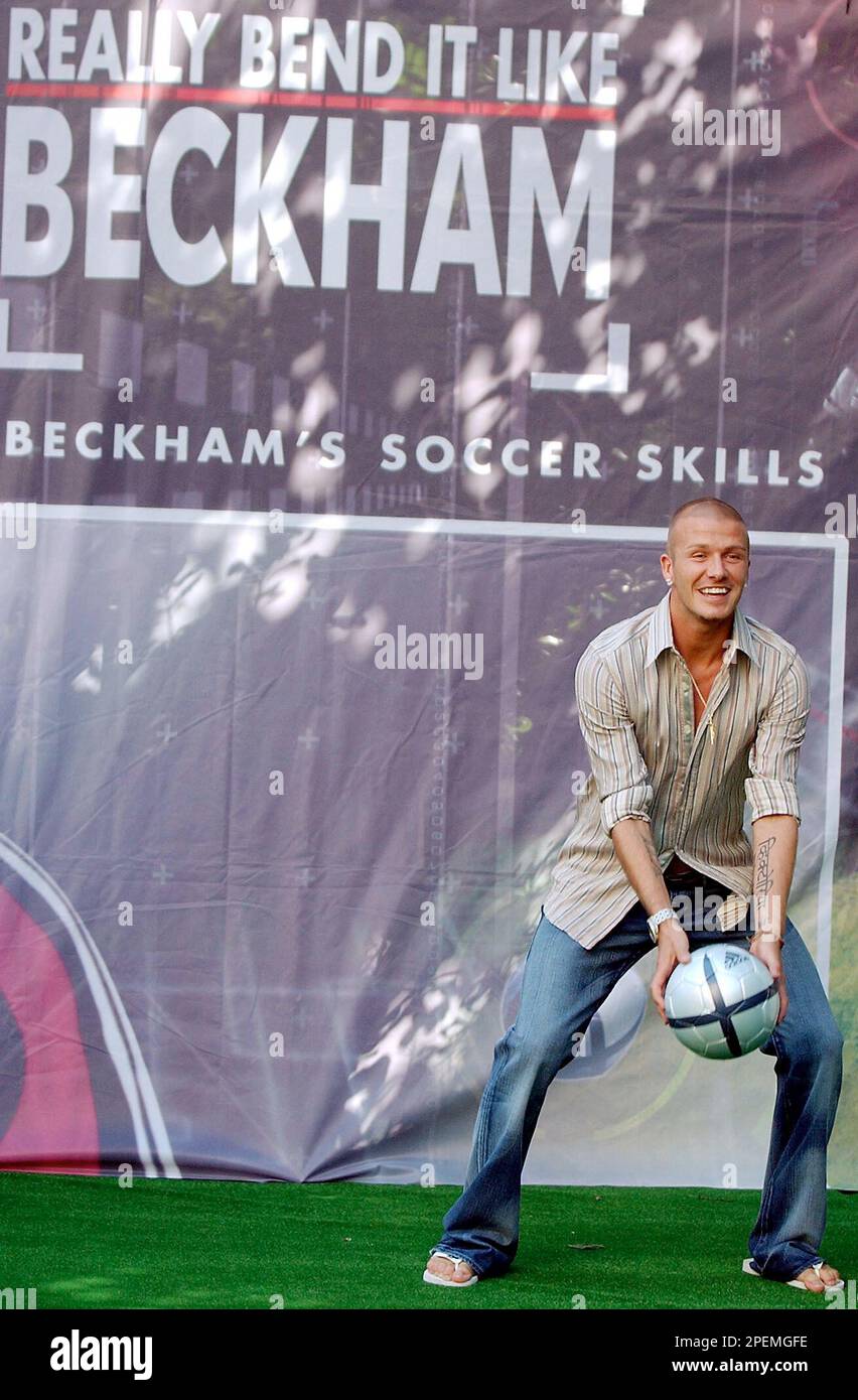 English striker David Beckham shares a ball with Molly Dale who co ...