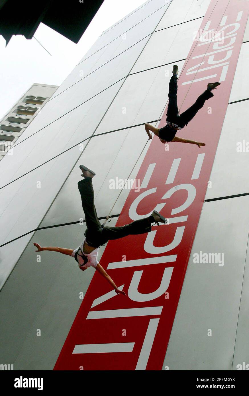 Two model-athletes from Germany abseil down the facade of Raffles City ...