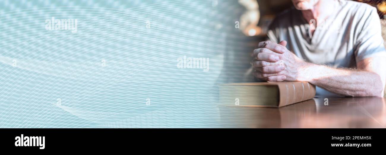 Man sitting at a table praying hands on a bible; panoramic banner Stock ...