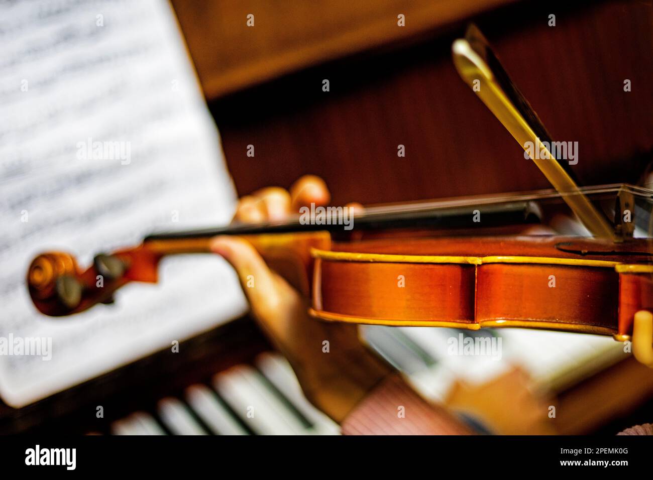 bow in motion on a small violin during a musical concert. horizontal ...