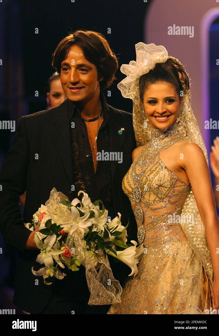 The Egyptian designer Hani Bihairy, left, stands with a model ...