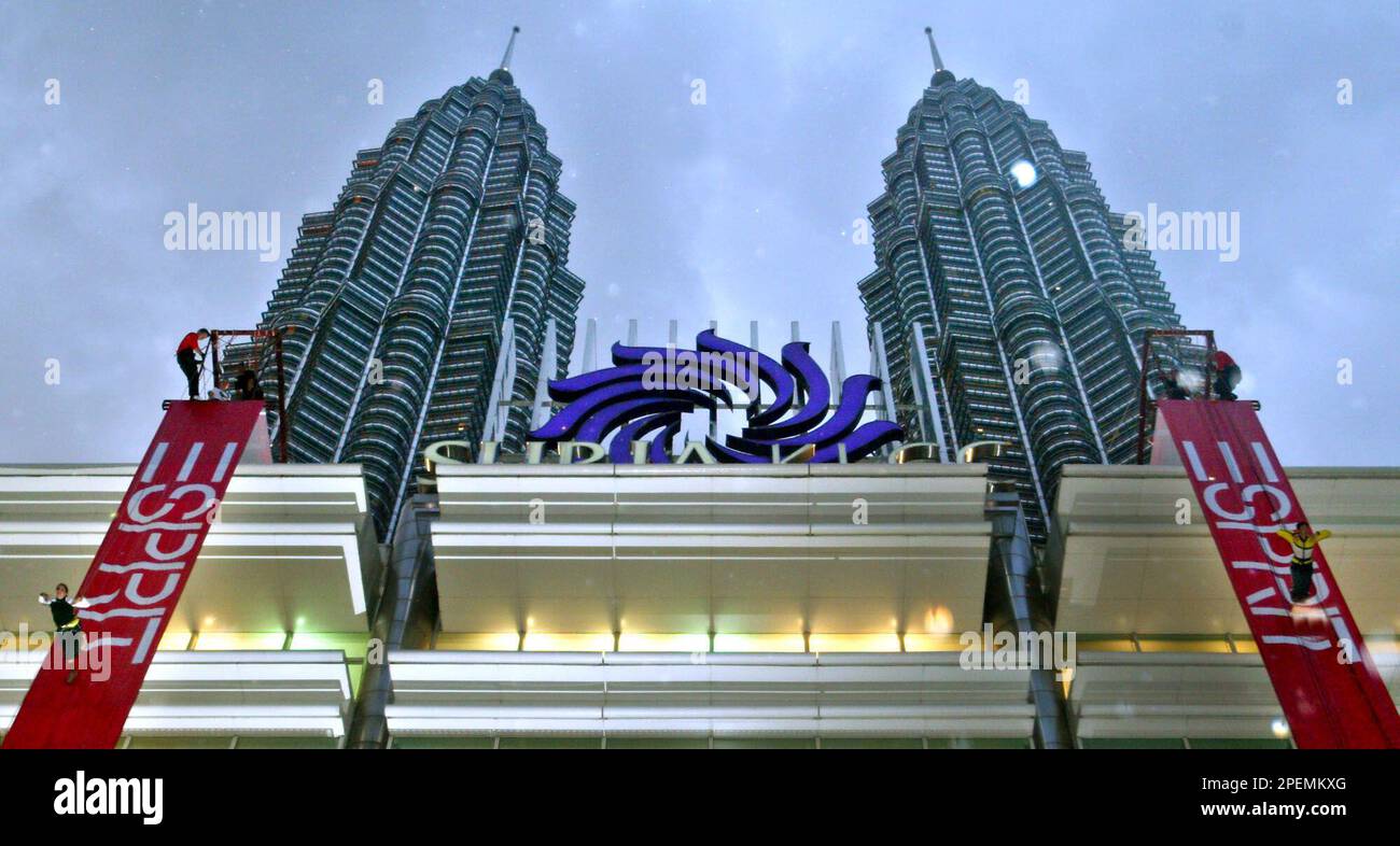 With the backdrop of Petronas Twin Towers, models walk down from the ...