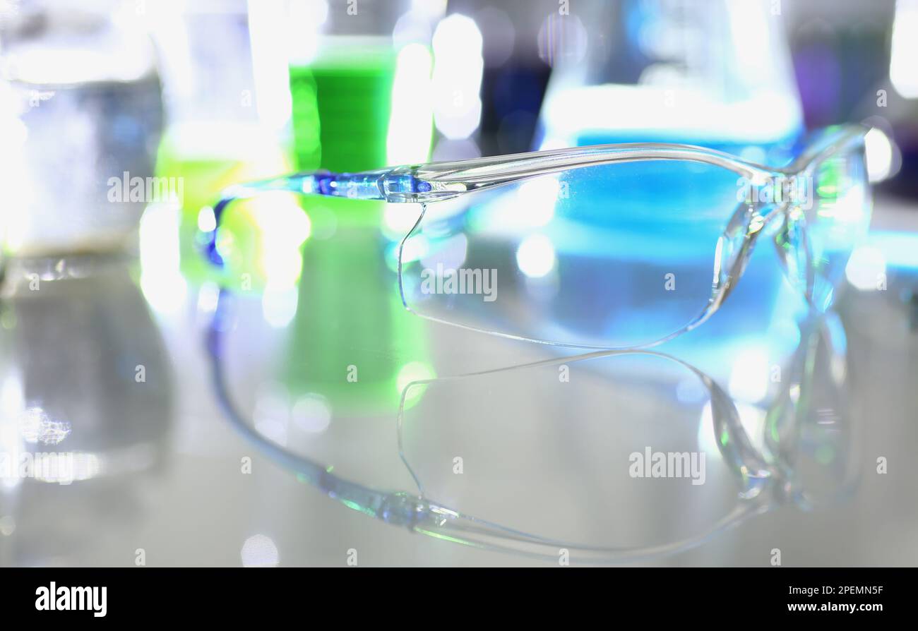 Transparent glasses and chemical liquids in test tubes in laboratory ...