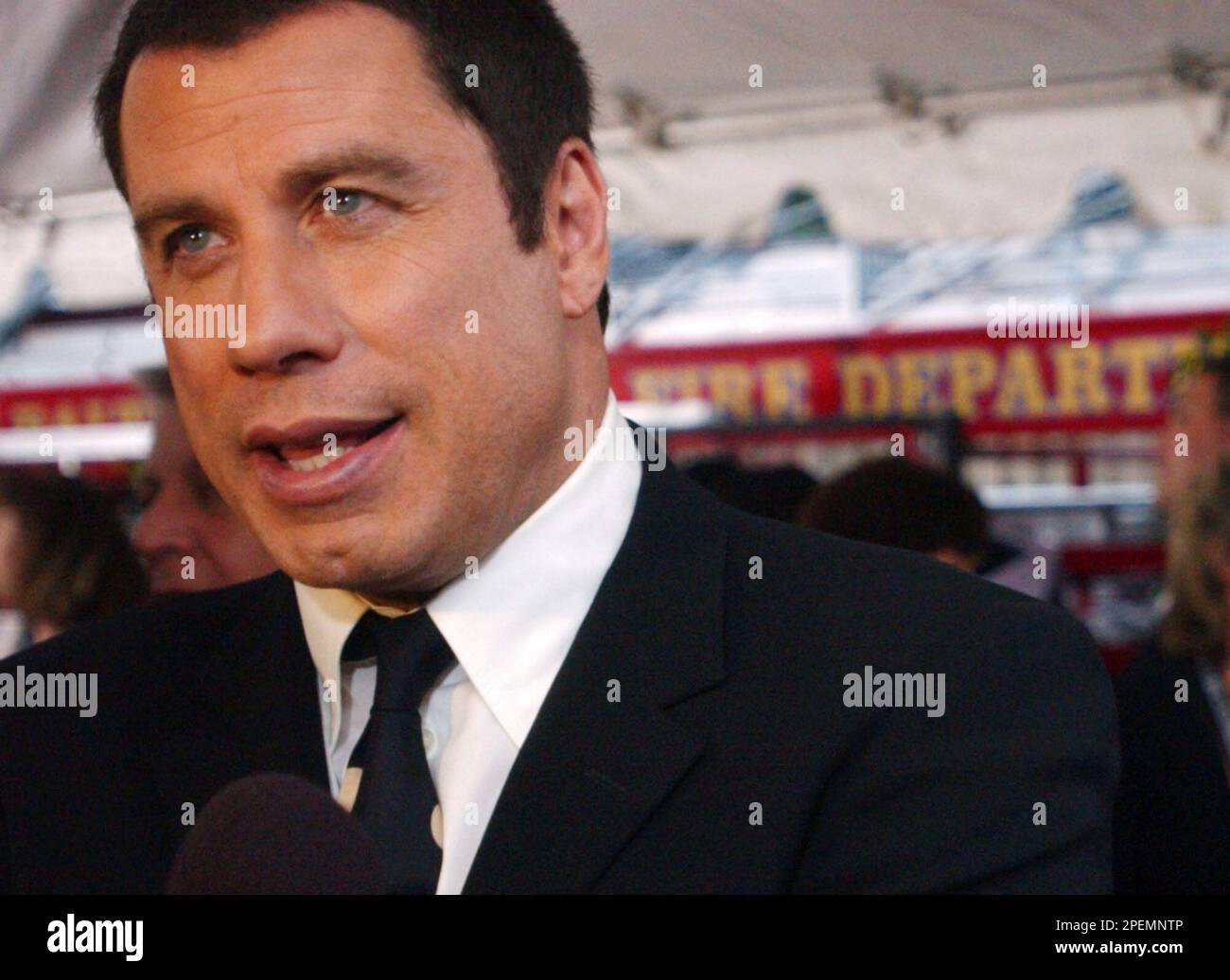 "Ladder 49" star John Travolta speaks with reporters Monday, Sept. 27 ...