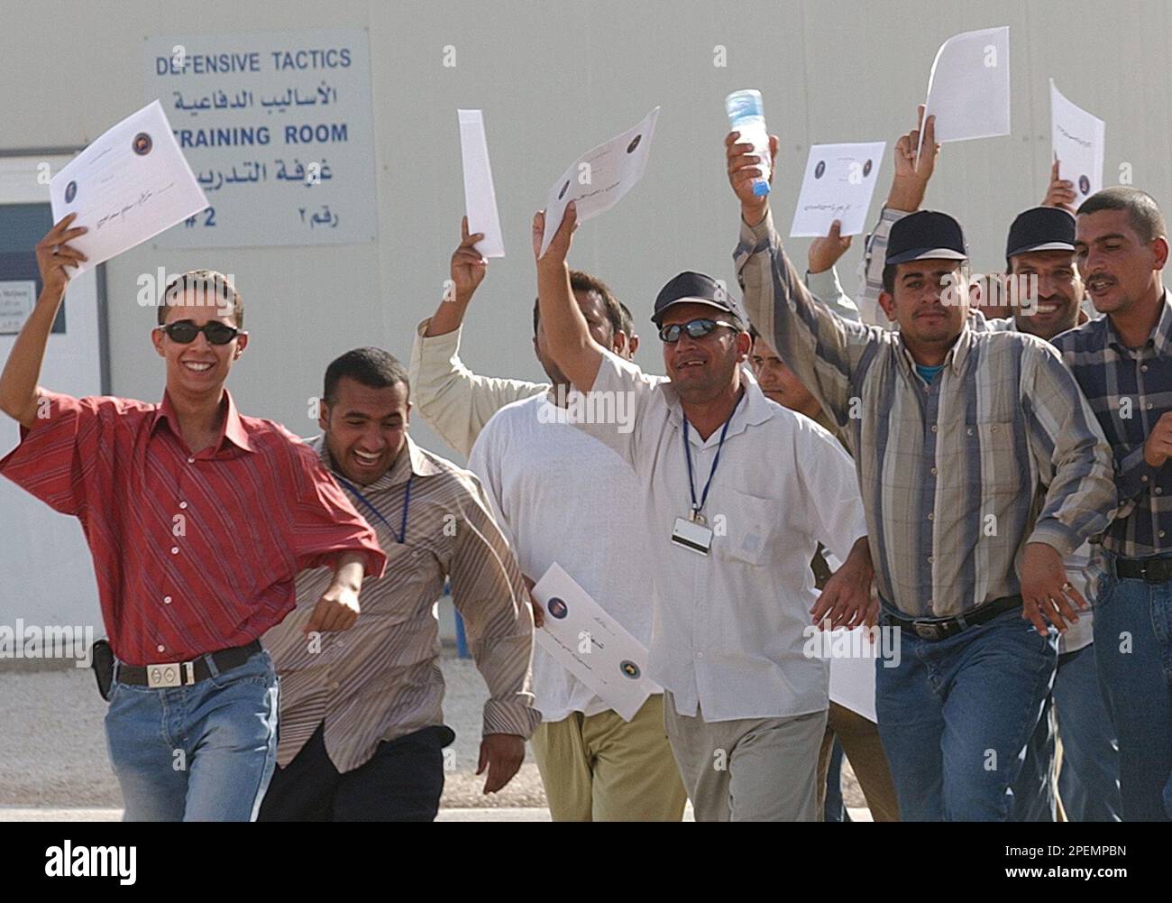 A group of new Iraqi border guards hold their certificates as they ...