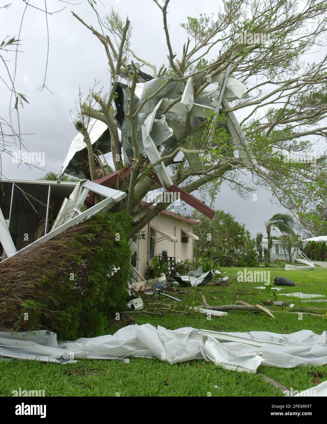 The roof of a trailer in Bearfoot Bay, Fla. is snagged in a tree Sunday ...