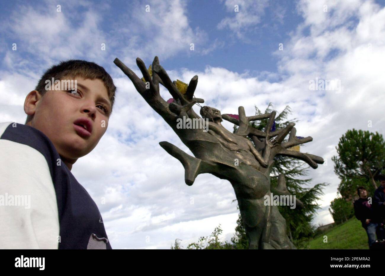 A Gypsy boy stands near the statue dedicated to to the Gypsy martyr ...