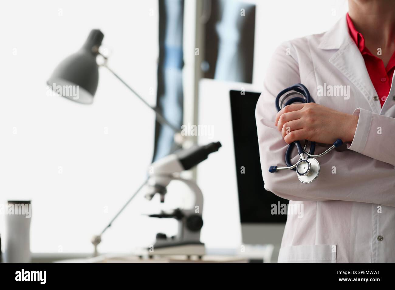 Doctor cardiologist or therapist with stethoscope in medical office ...