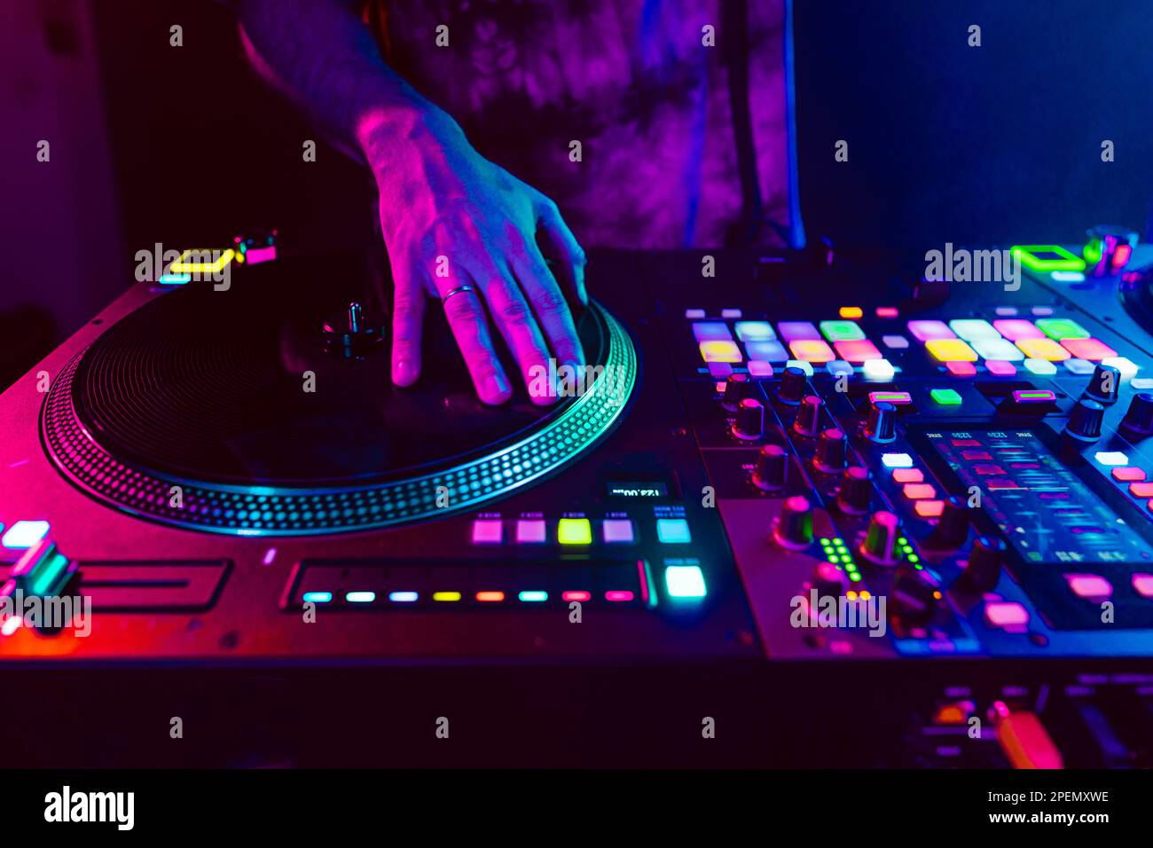 Close up of DJ hands on dj console mixer during concert in the club ...