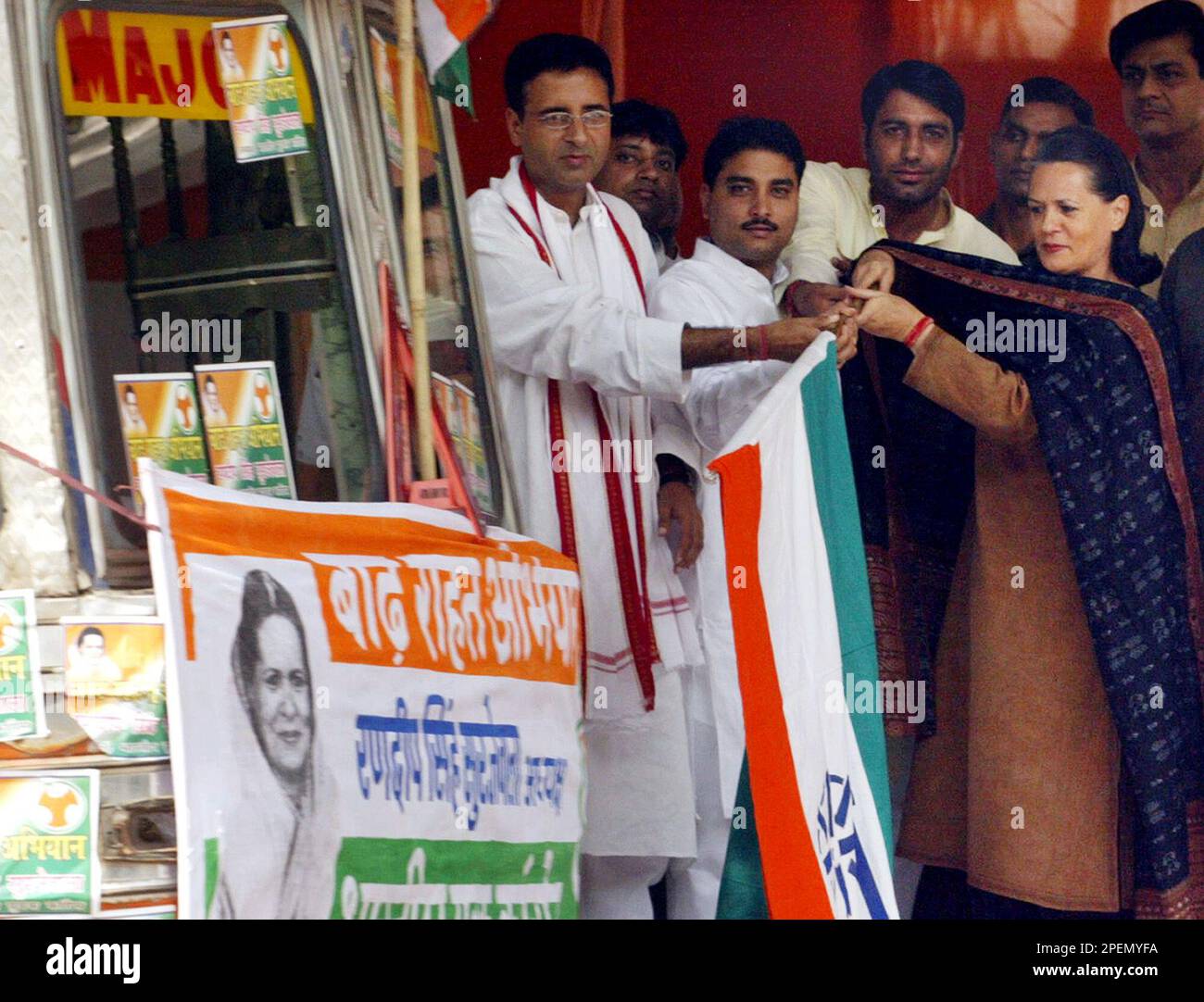 Congress party president Sonia Gandhi,right, flags off trucks carrying ...