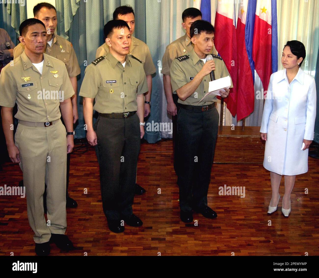 Philippine President Gloria Macapagal Arroyo, right, listens to a ...