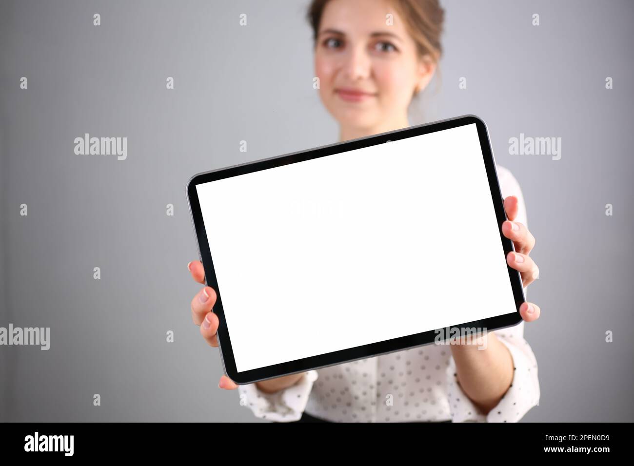 Smiling beautiful woman is holding advertising tablet Stock Photo - Alamy