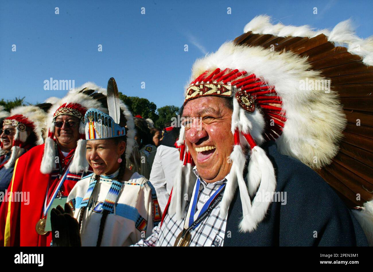 Chief George Old Crow, right, of Yukon, Okla., laughs as he and ...