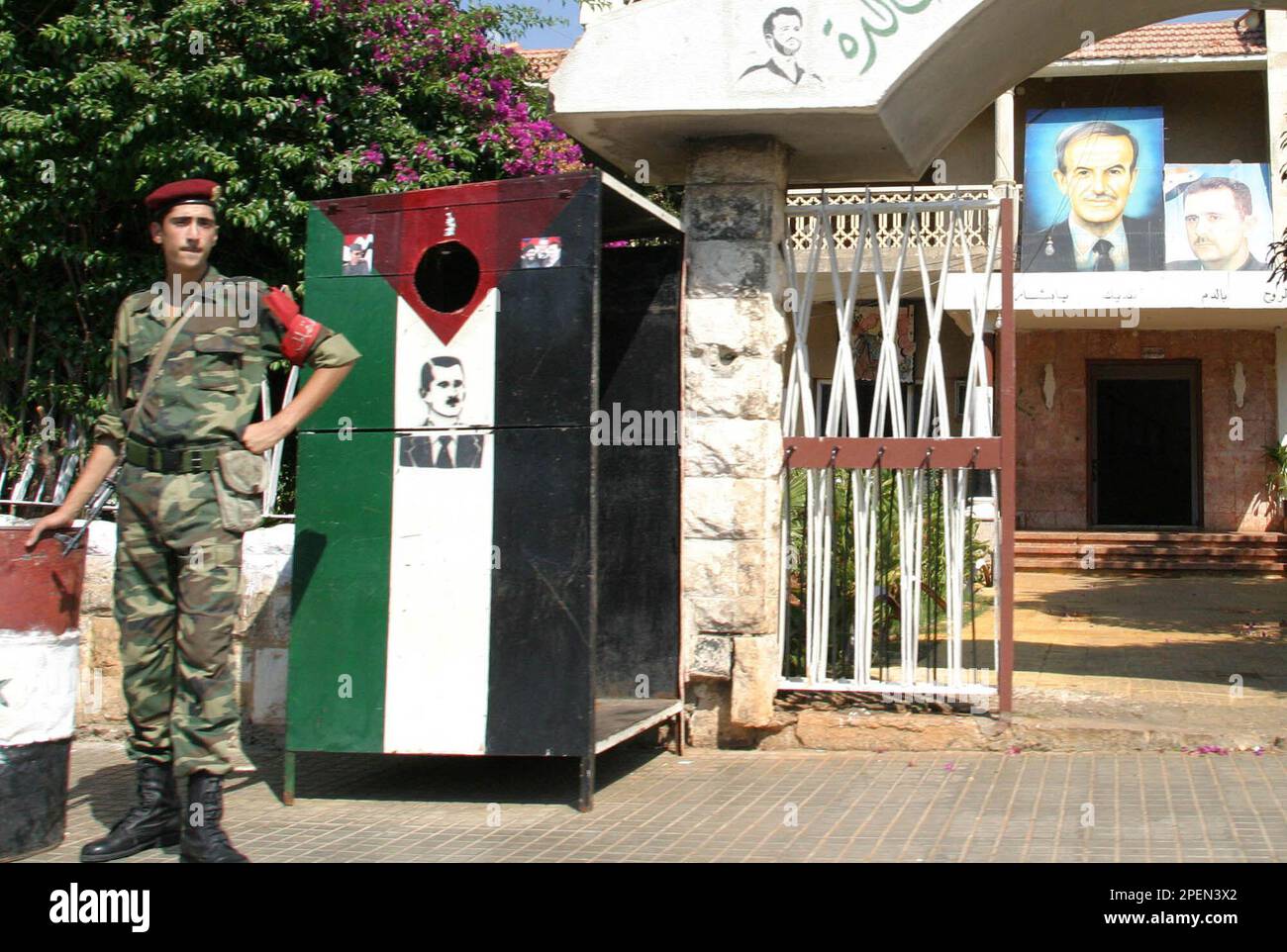 A Syrian soldier stand guards their position in Aramoun, south of ...
