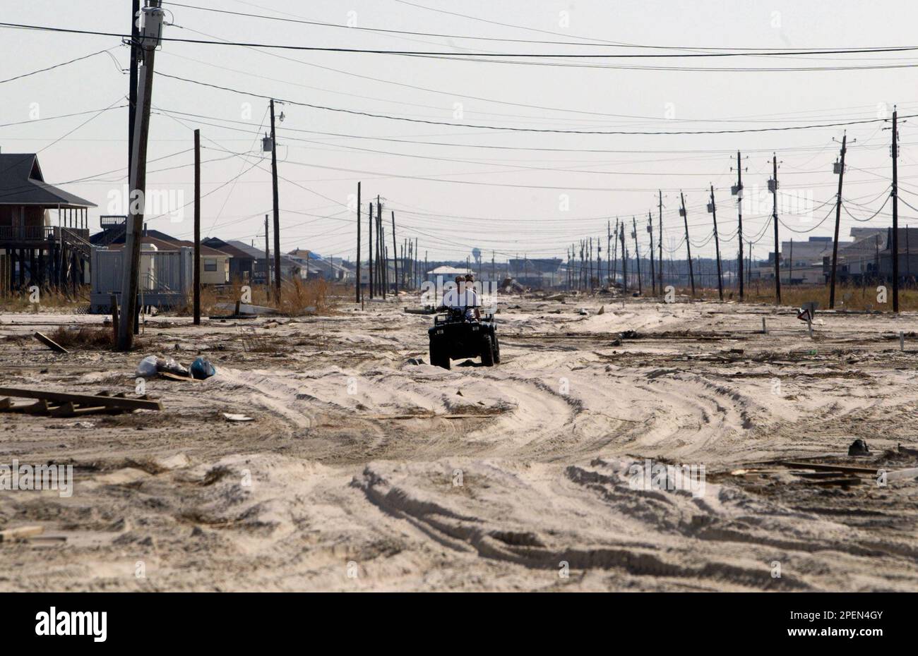 Bill and Beth Major navigate the sand covered streets of Dauphin Island ...