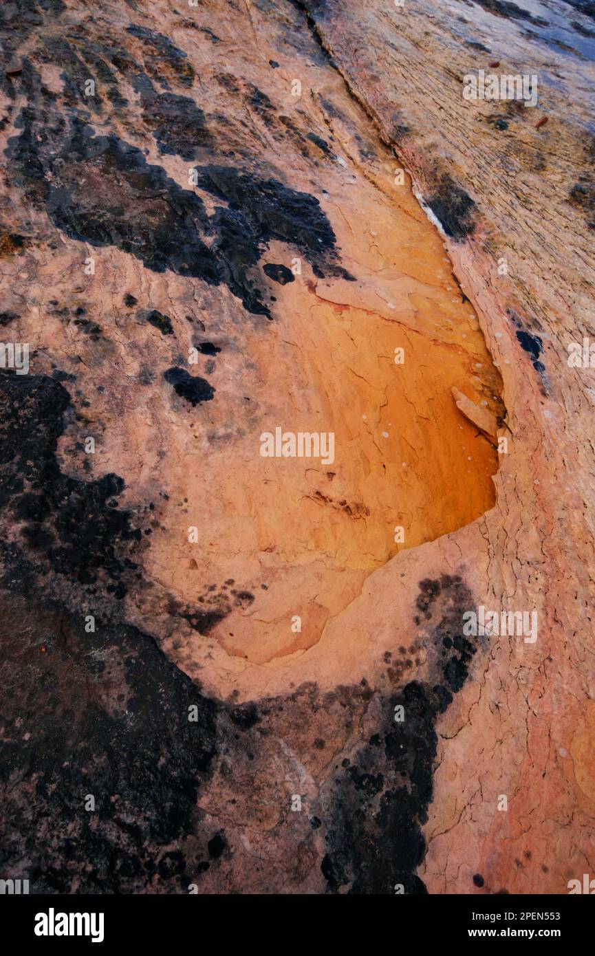 Colorful orange and black rock structures in riverbed on the plateau of ...