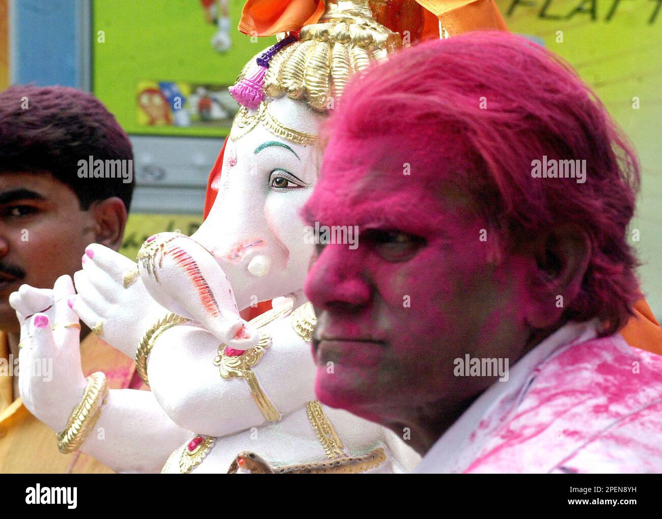 Indian Hindu men carry an idol of elephant headed Hindu God Ganesh on ...