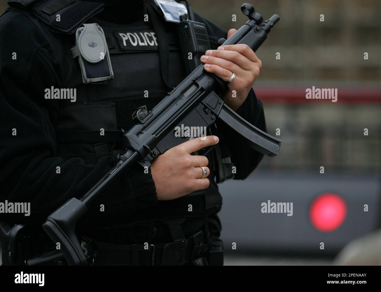 A policeman carrying a semi-automatic gun stands outside the Palace of ...