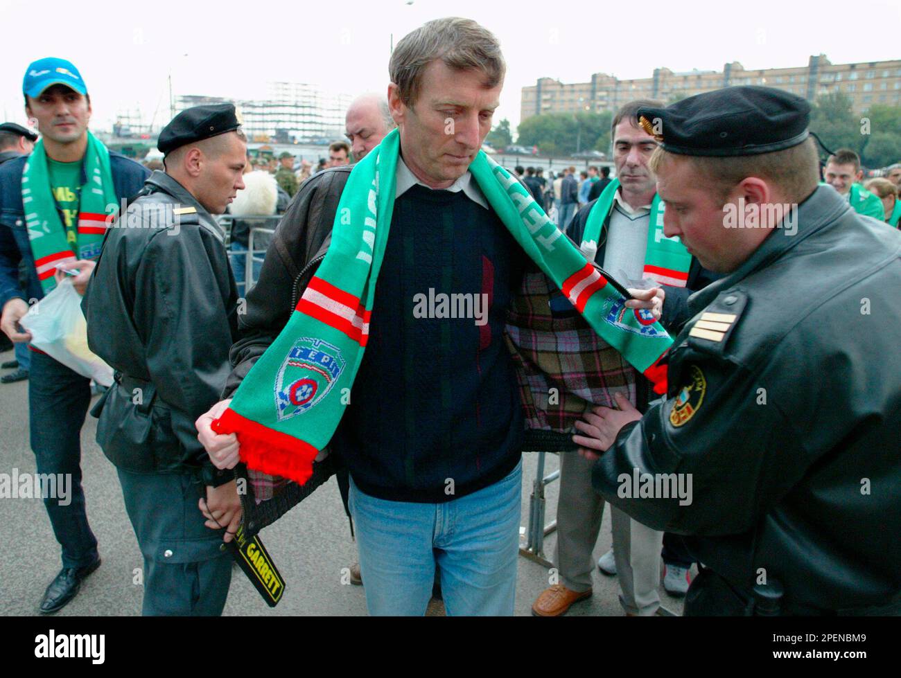Police officers search Chechen soccer team fans wearing the team's ...