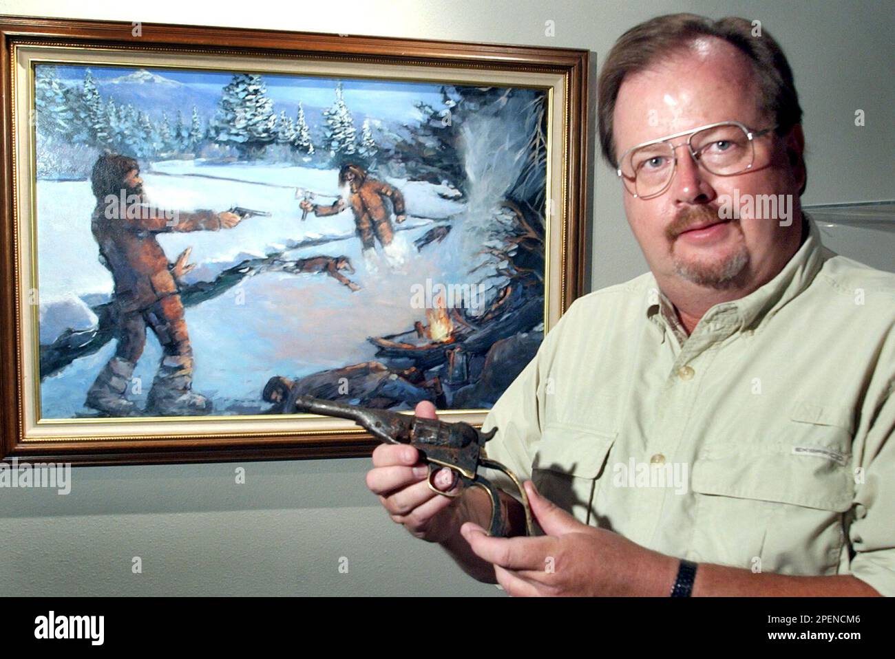 David Bailey, curator of the Western Museum, holds a pistol, at a ...