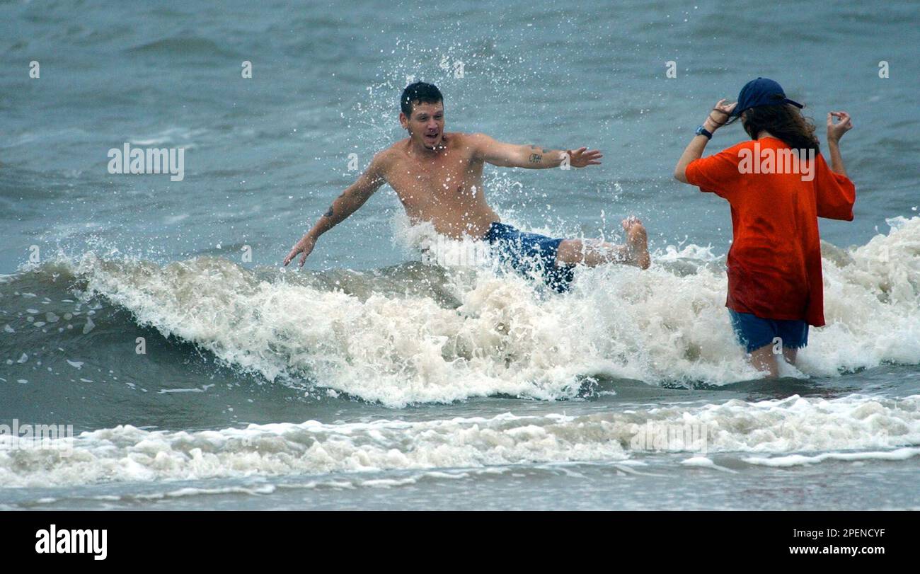Gulf Coast residents play in the surf along the beach in Biloxi, Miss ...