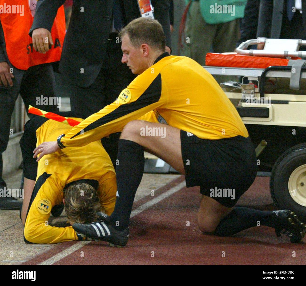 Swedish referee Andres Fisk, left, kneels down after an unidentified ...