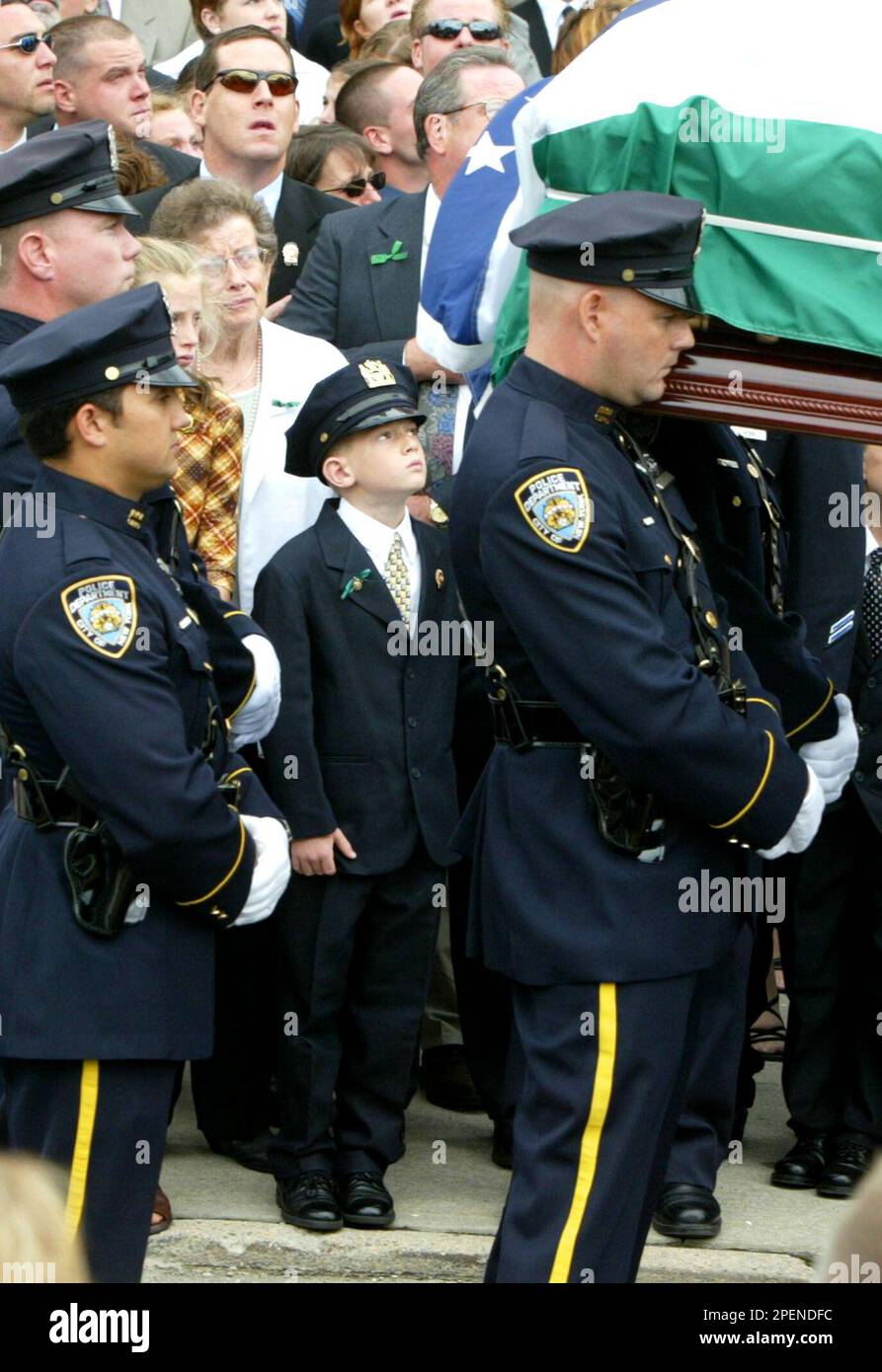 Kevin Rafferty, 9, wearing his fathers police cap, watches along with ...