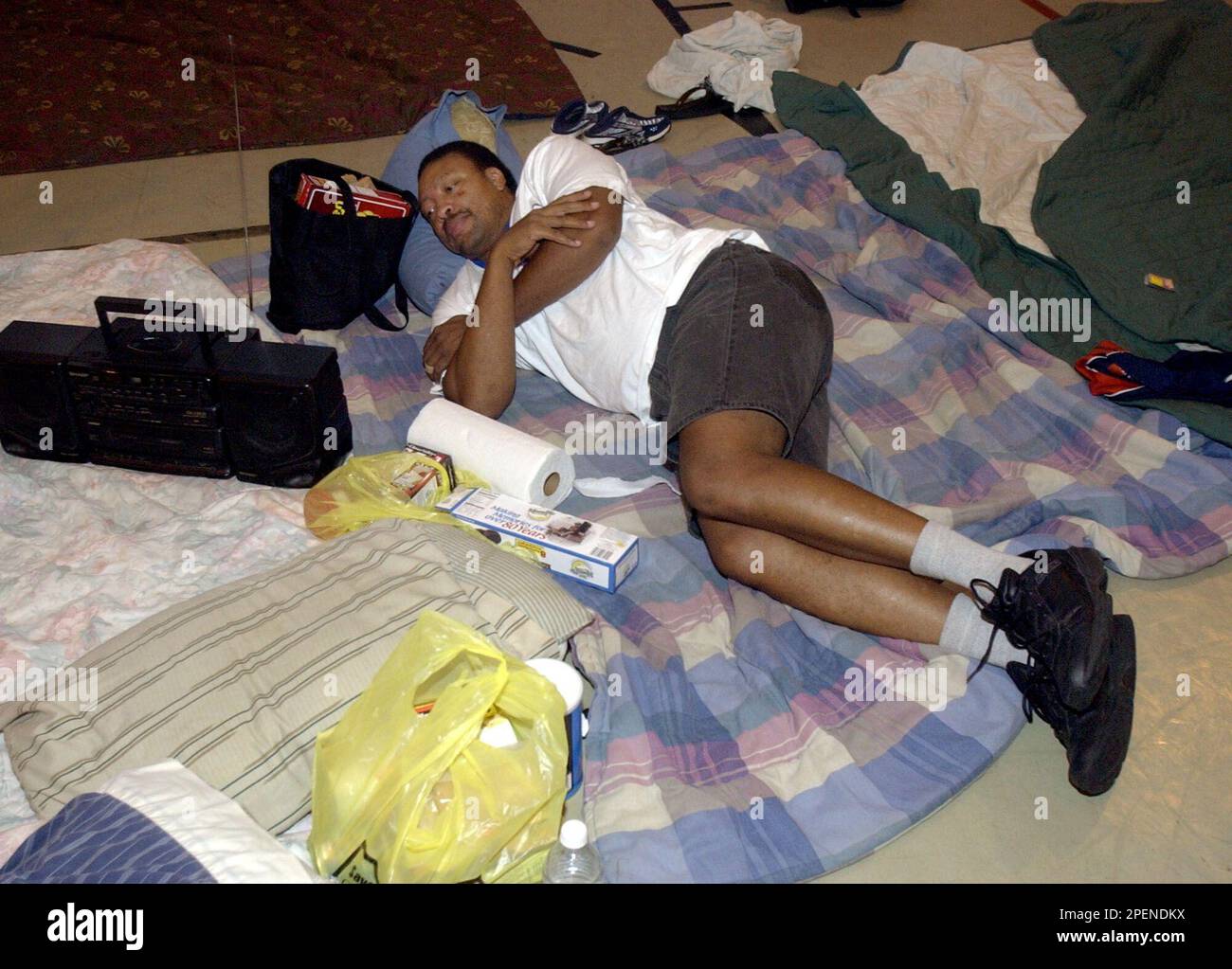David Smith, of Gulfport, Miss., listens to the radio while riding out ...