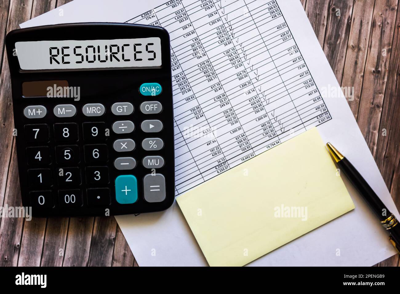 resources word on calculator display and charts on wooden background ...