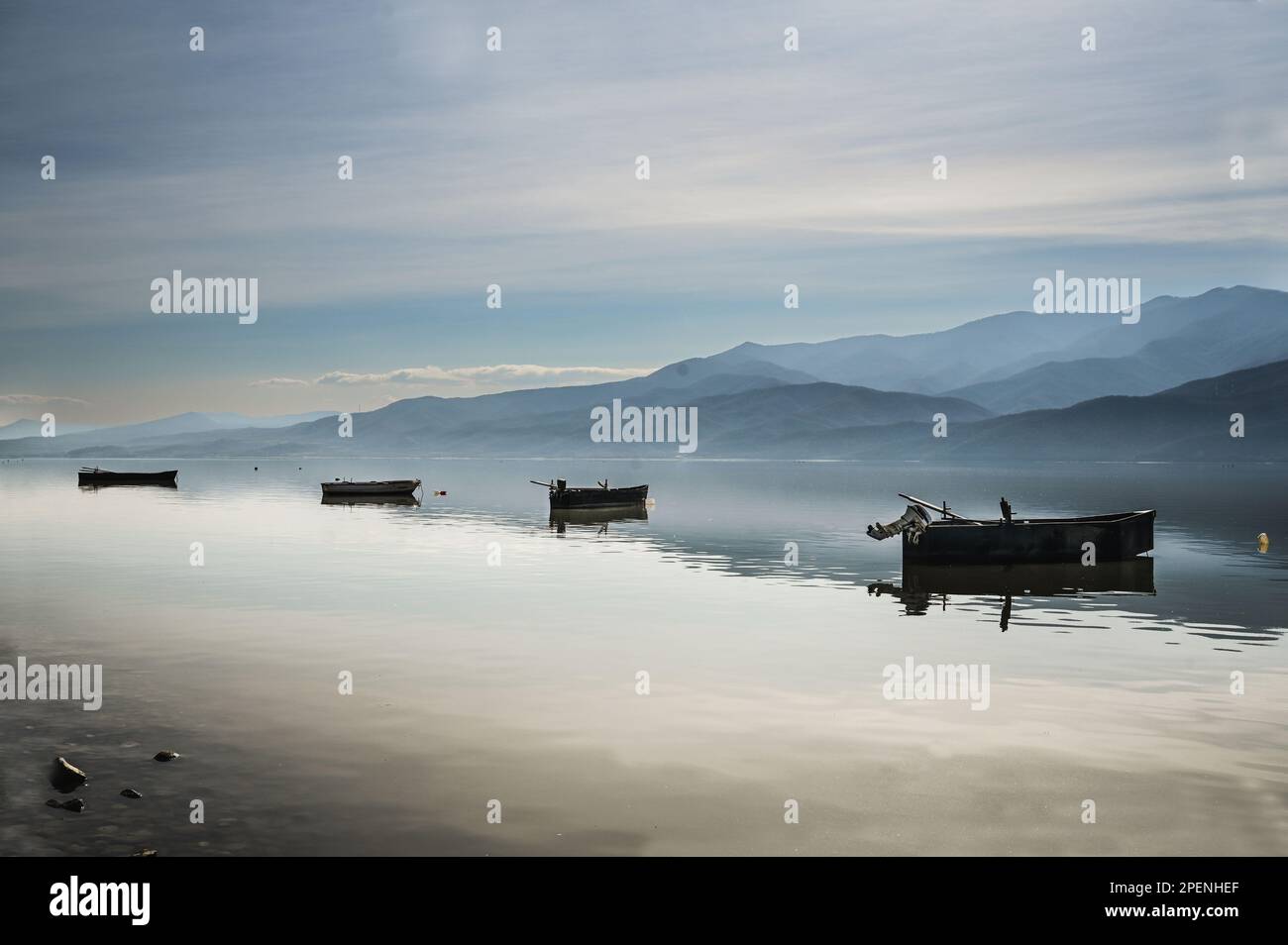 A stunning landscape featuring multiple small boats floating in a ...