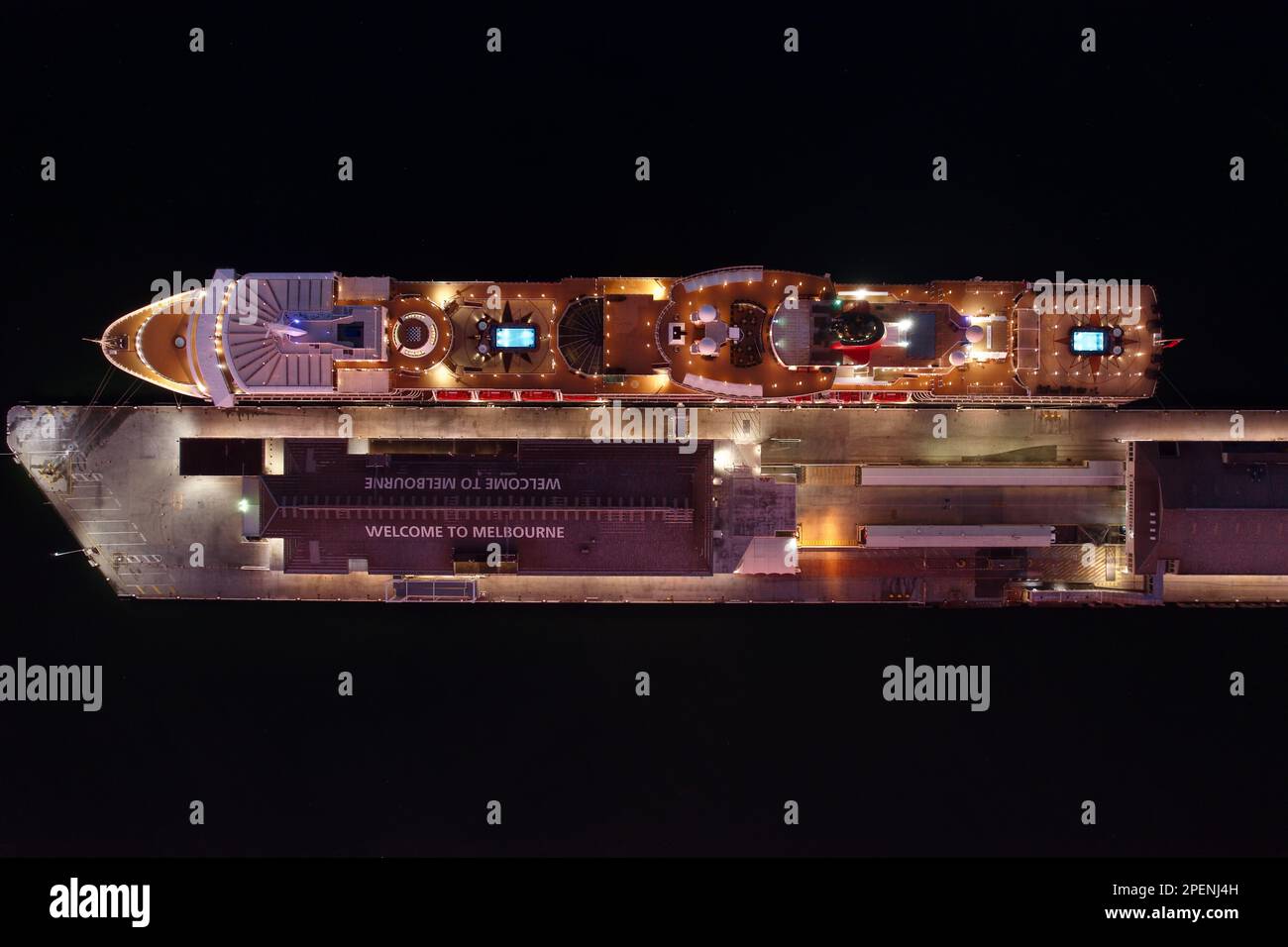 A large vessel emitting bright light from its hull is pictured in the ...