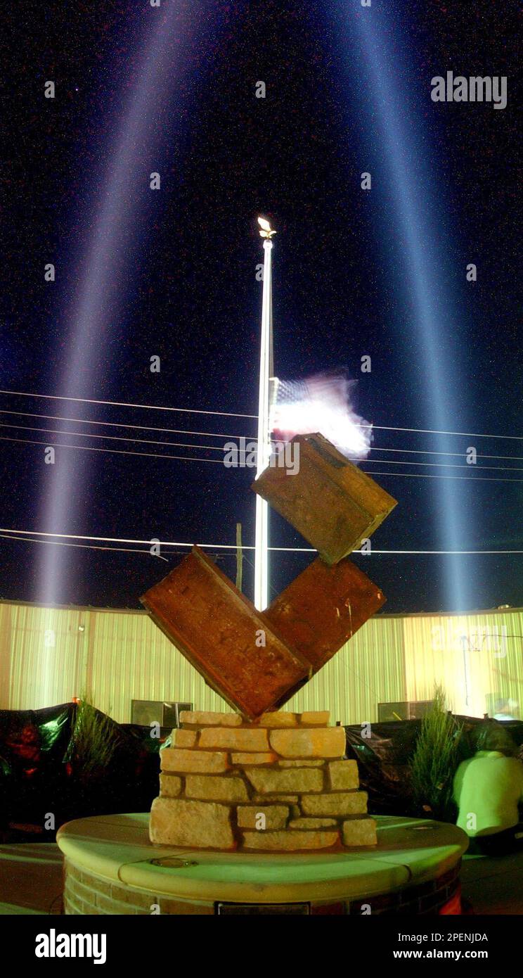 Two beams of lights shine into the night sky from a memorial built in ...