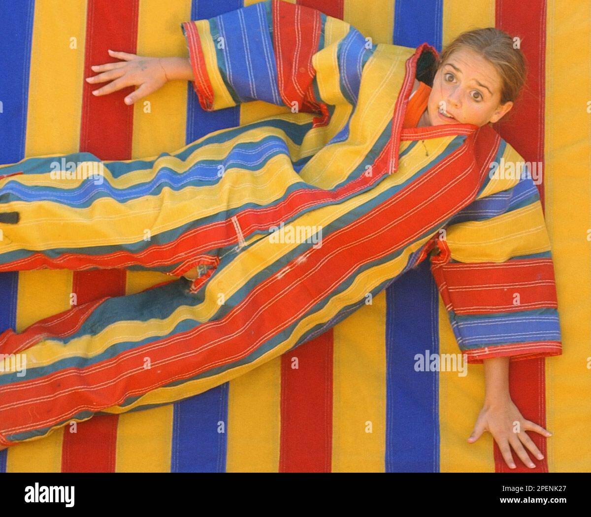 Katelyn Stoss sticks herself to a velcro wall after jumping to it from ...