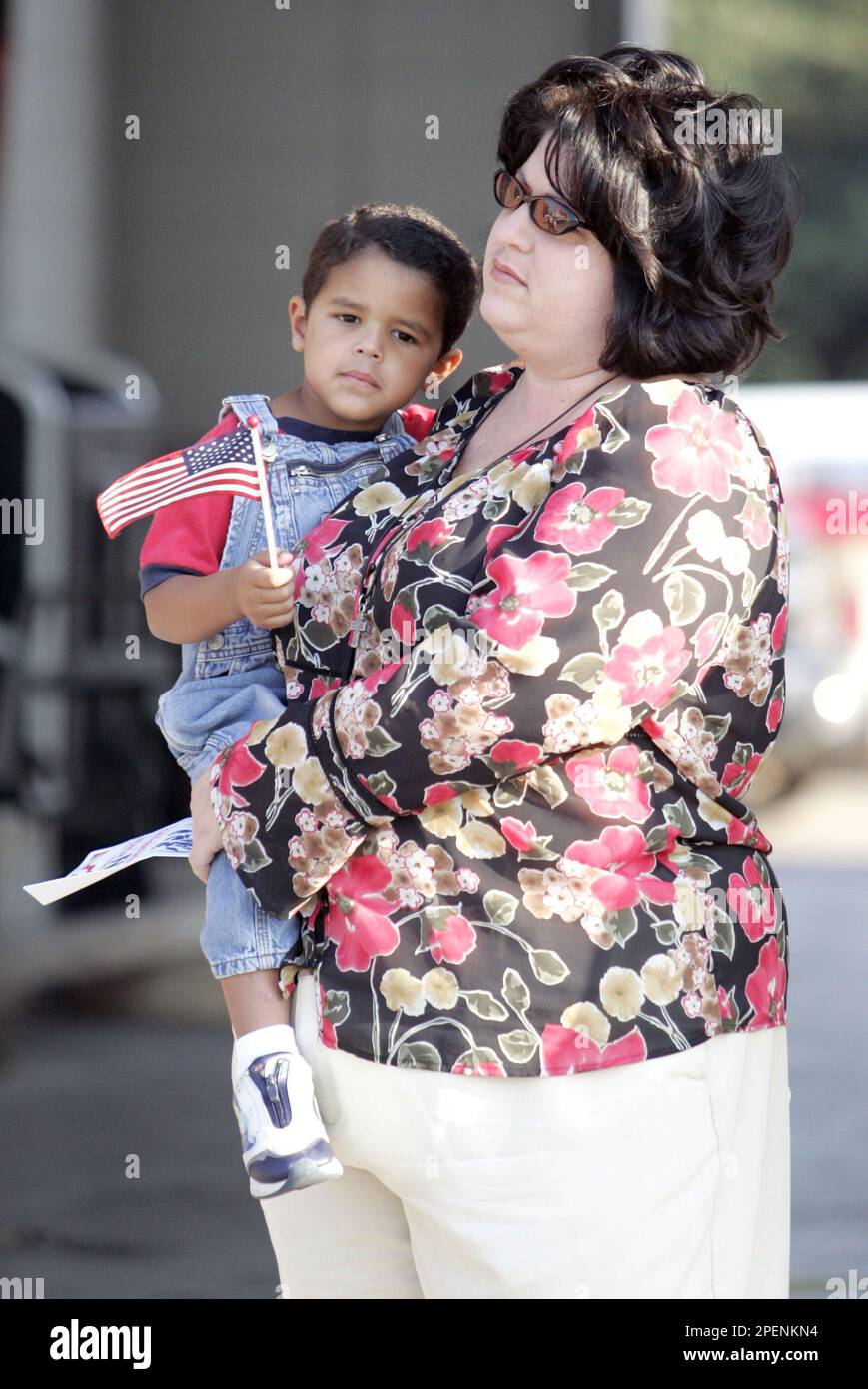Marlos McCraw, 3, waives an American flag as he and his mother Jennifer ...