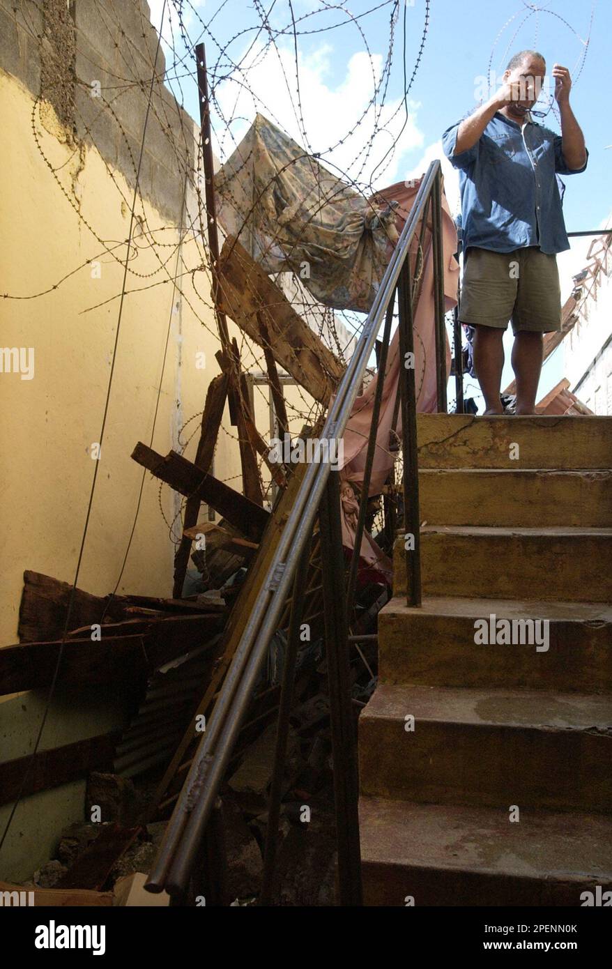 Former Deputy Prime Minister Bernard Coard removes his glasses while ...