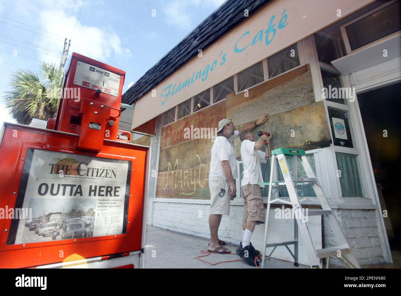 Brian Belanger, center, and Mark Beymer, right put up plywood at ...