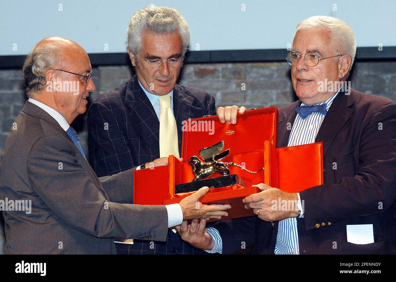 Italian Culture Minister Giuliano Urbani, left, hands a Golden Lion for ...