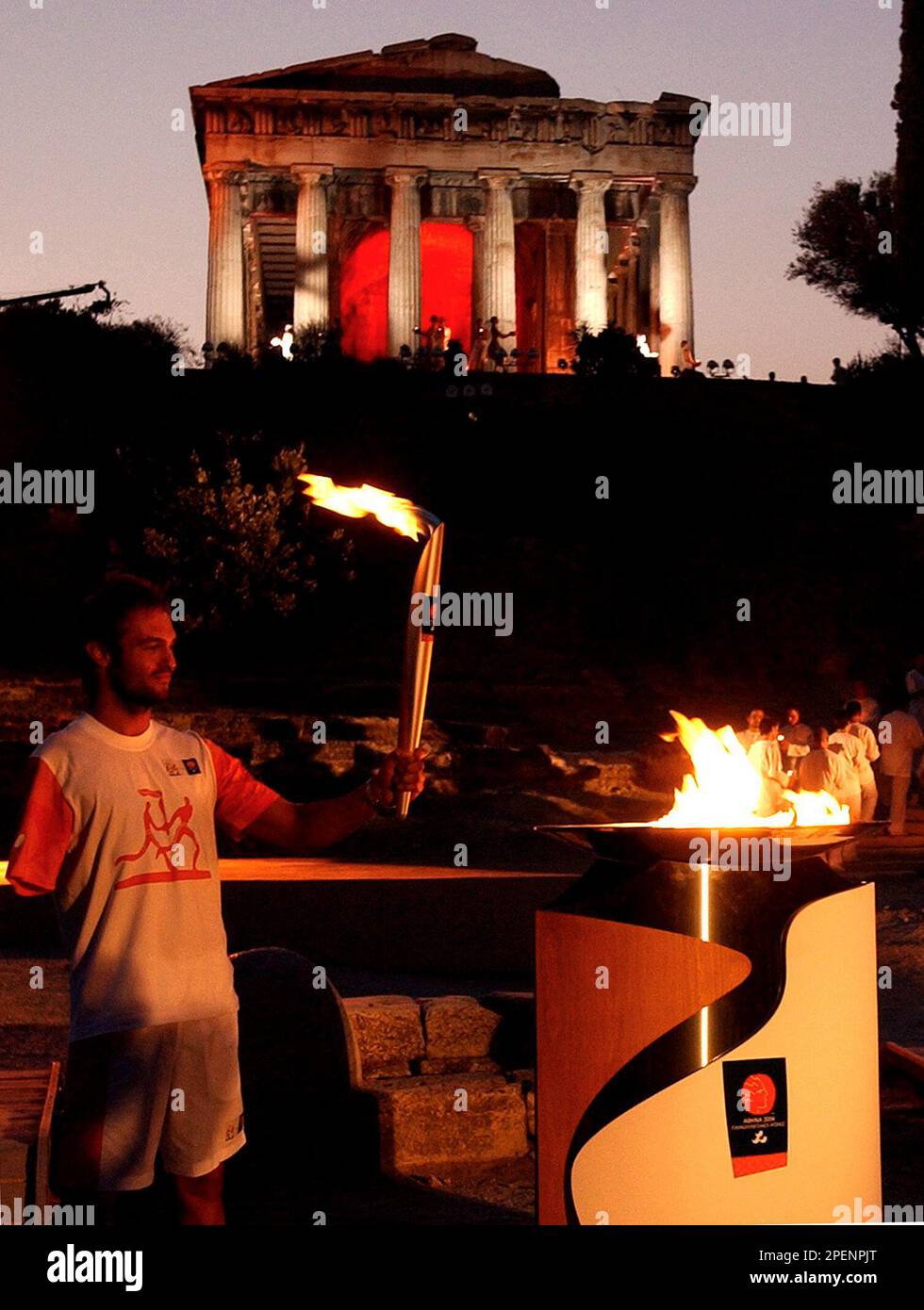 Paralympic swimmer Costas Fykas carries a torch with the flame for the ...