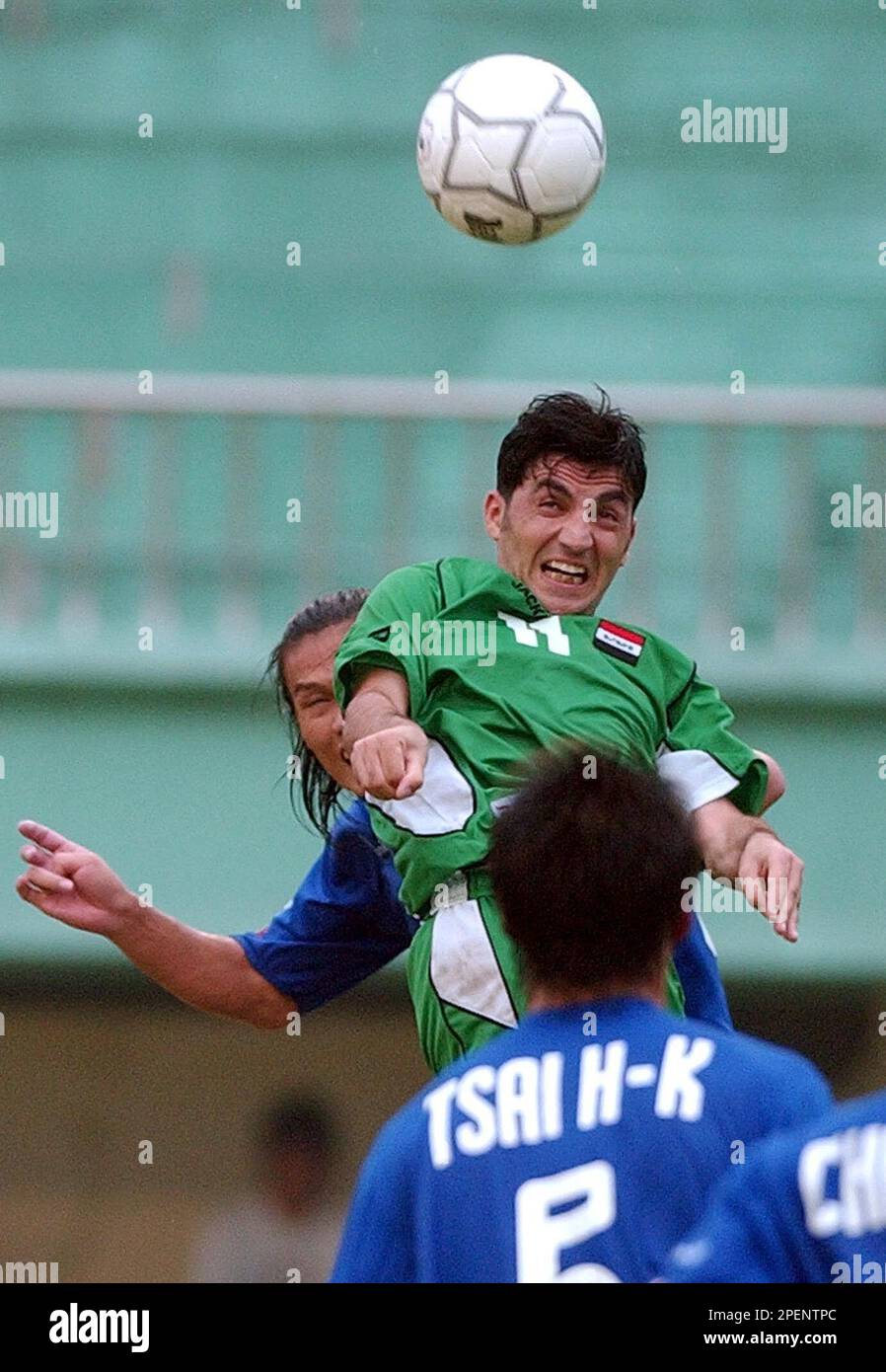 Iraq's Hawar M.M. Taher heads a ball in a scrum with Taiwan during a ...