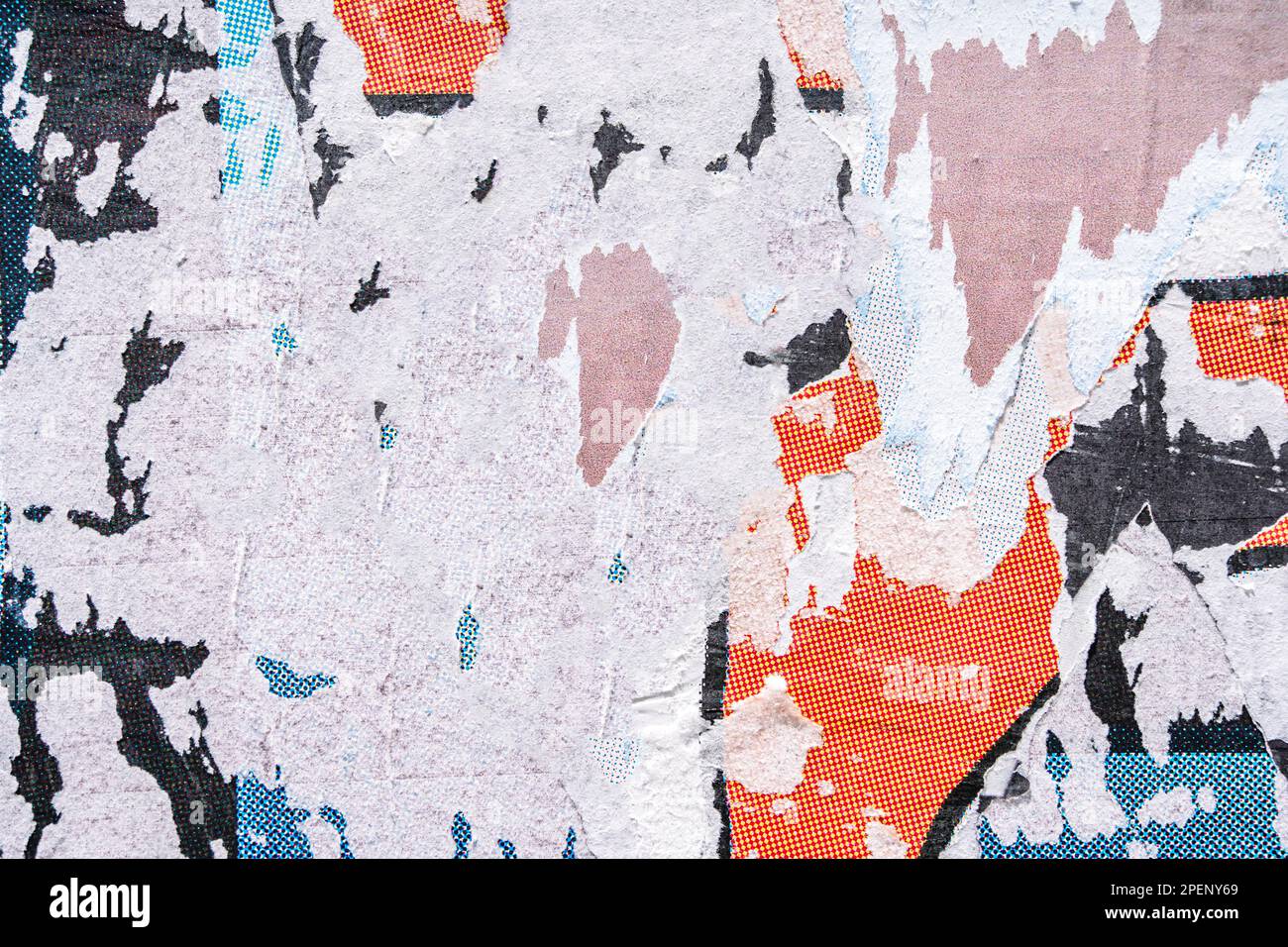 Torn paper collage background on an old poster on a street wall ...