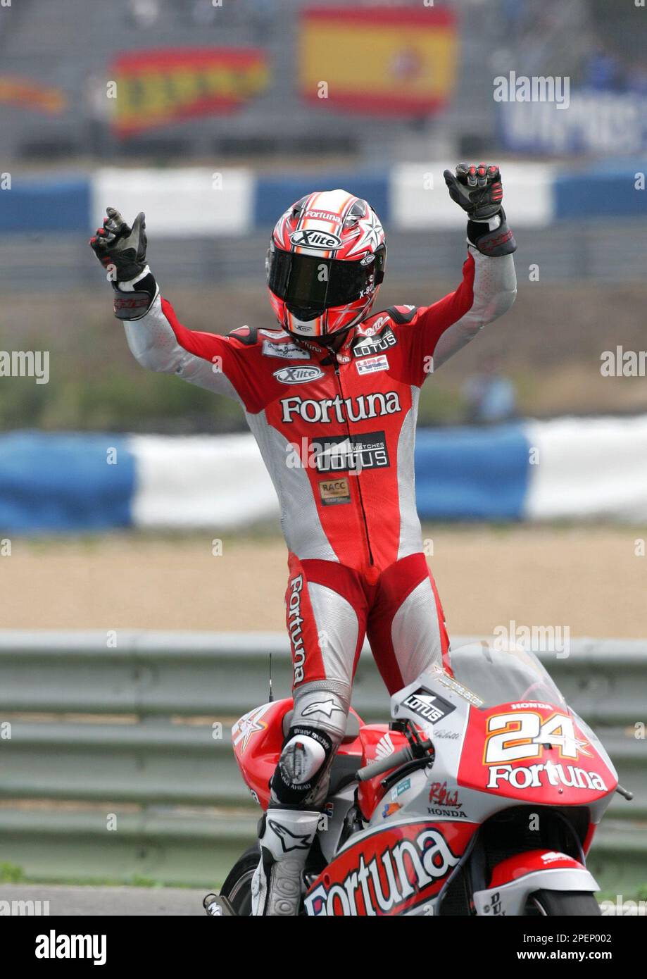Spain's Toni Elias waves to fans from atop his 250cc Honda celebrating ...