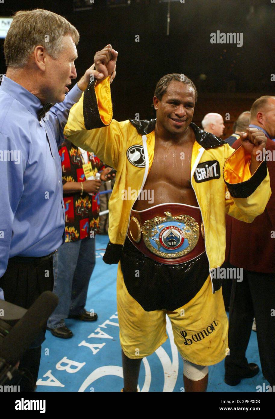 Referee Jay Nady holds up the hand of Lamon Brewster, of Los Angeles ...